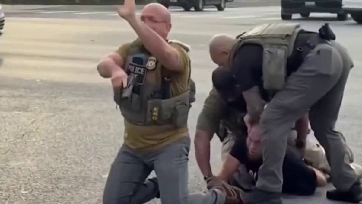 Video shows officer drop gun then appear to point it during apparent ...